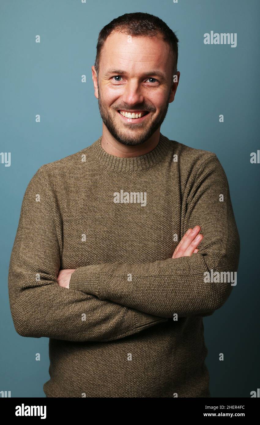 Portrait of a beautiful happy man in front of a colored background ...