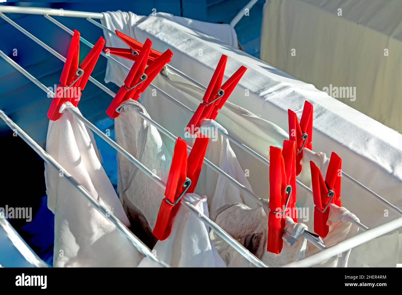 red peg at clothesline with white clothes as symbol of cleaness Stock ...