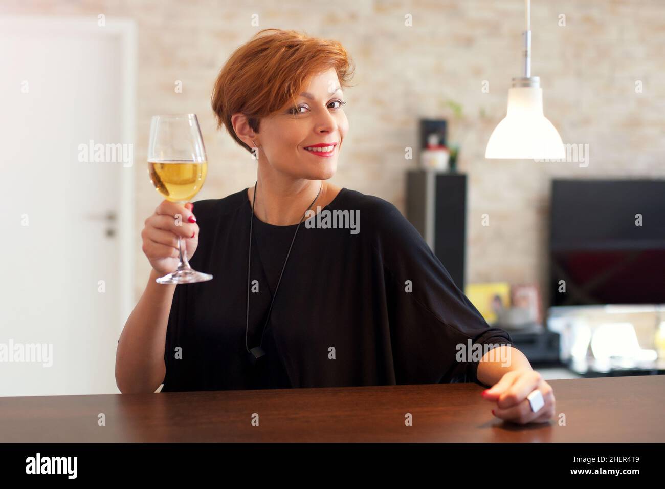 Portrait of attractive young adult woman applying blusher Stock Photo ...