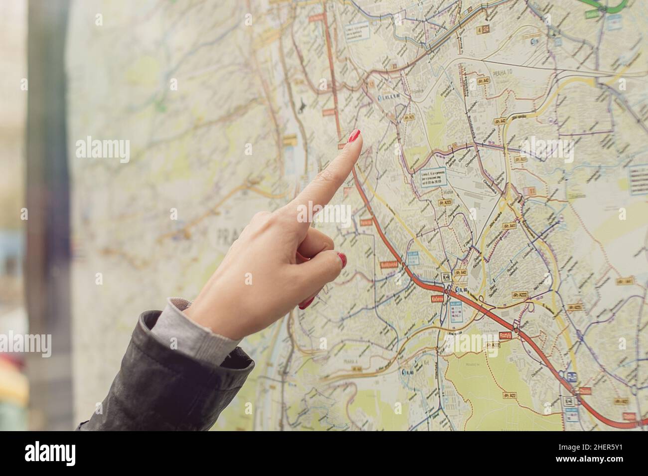 Female tourist looking at big public outdoor street map Stock Photo - Alamy