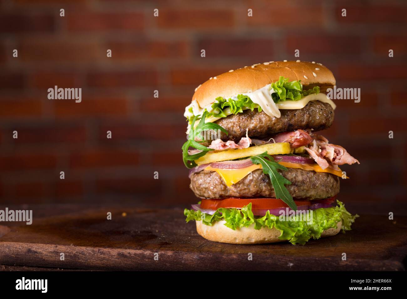 Fresh delicious double burger with meatball, cheese, tomato, onion ...