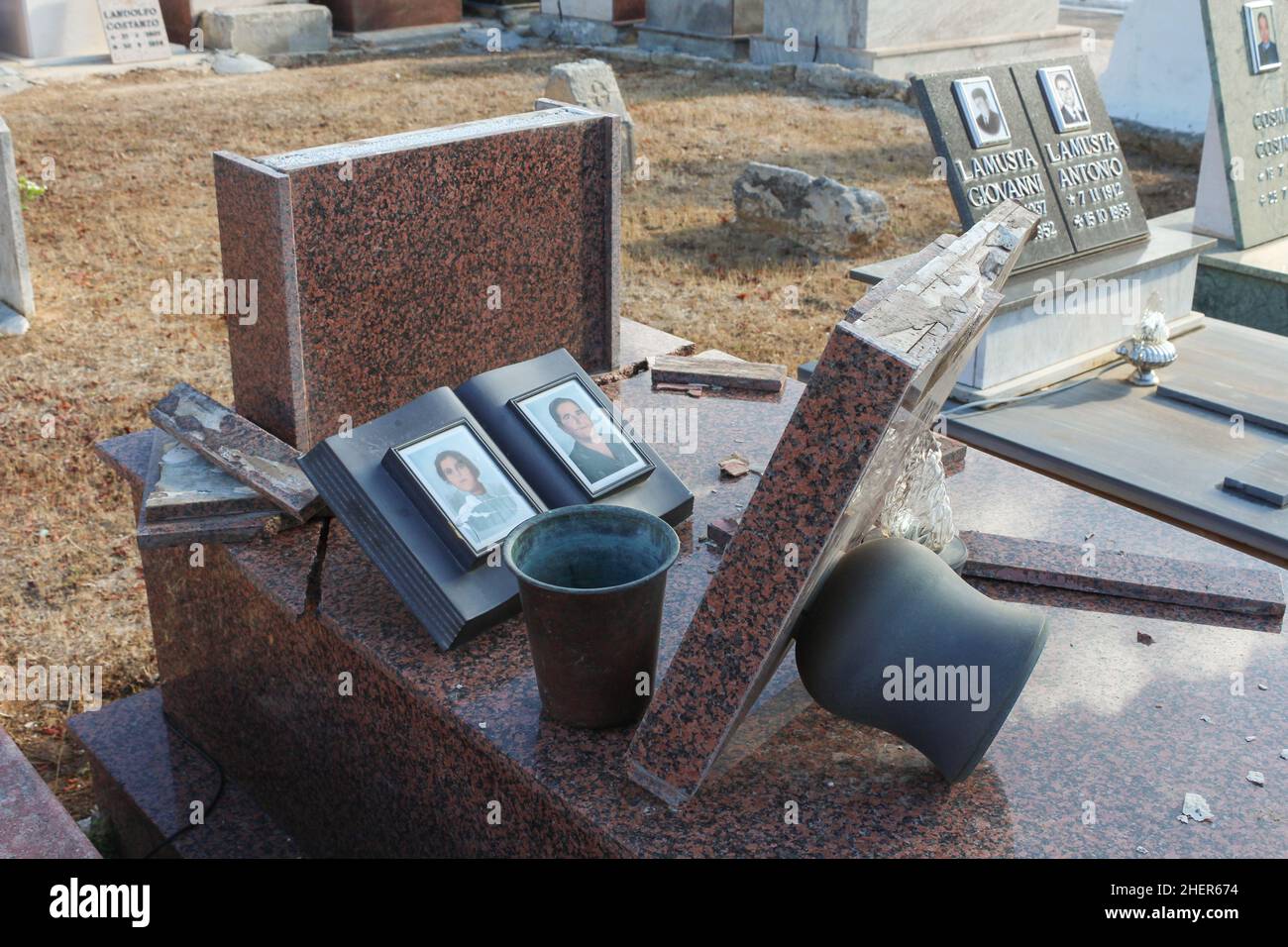 A broken gravestone made of granite, a desecrated grave, a profanation ...