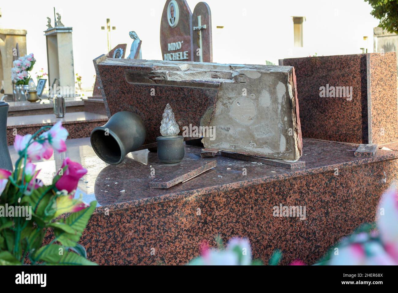 A broken gravestone made of granite, a desecrated grave, a profanation ...