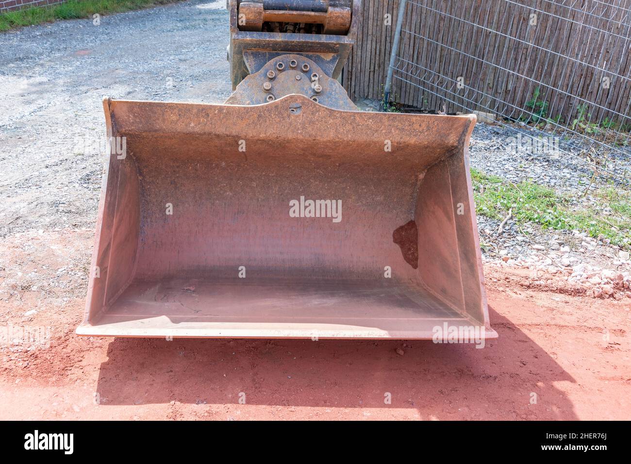 bucket of an excarvator in detail on red earth Stock Photo - Alamy