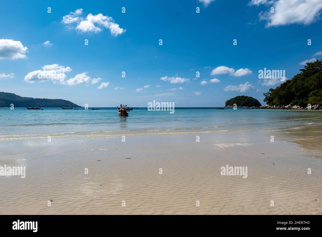Beach with clear water with white and golden sand, blue sky, in ...