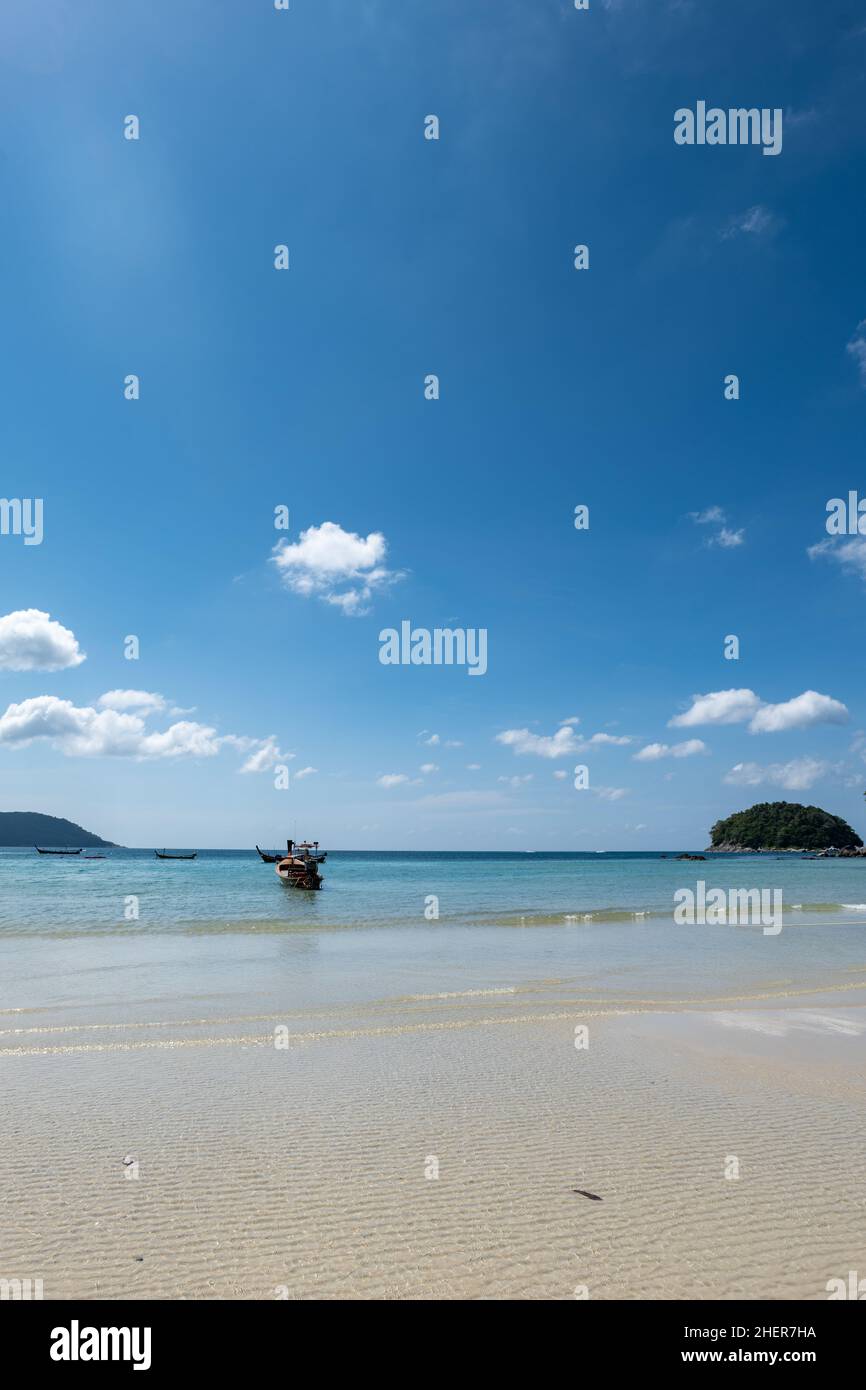 Beach with clear water with white and golden sand, blue sky, in ...