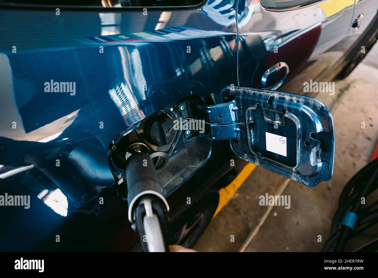 Hose plugged into a car made of LPG (liquefied petroleum gas) fuel at a ...