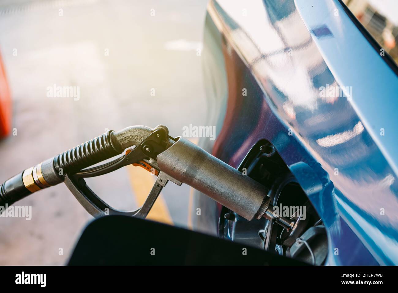 Hose plugged into a car made of LPG (liquefied petroleum gas) fuel at a ...