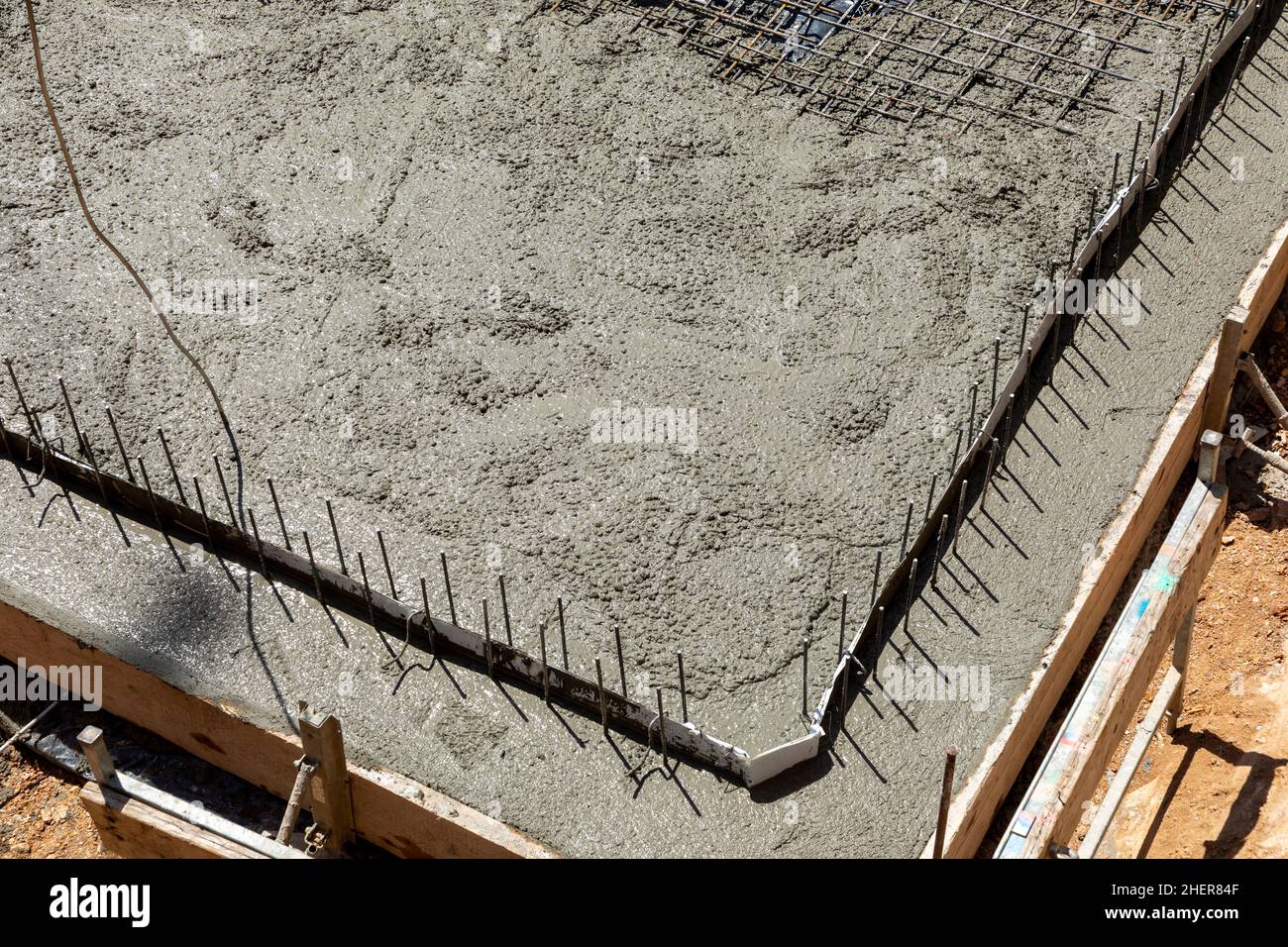 detail of iron rod at a concrete foundation with wet cement Stock Photo ...