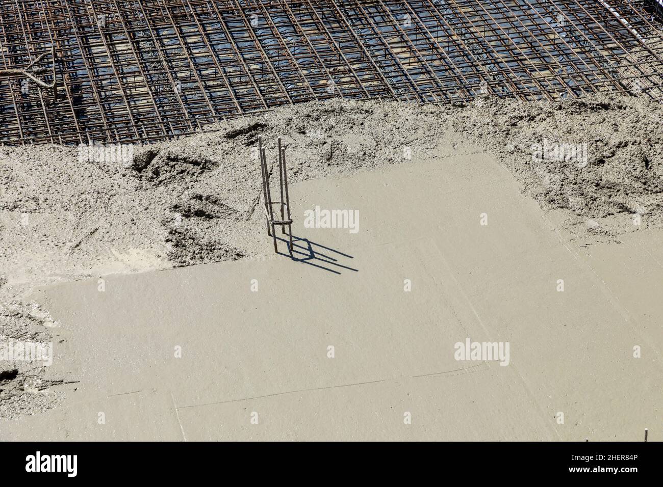 detail of iron rod at a concrete foundation with wet cement Stock Photo ...