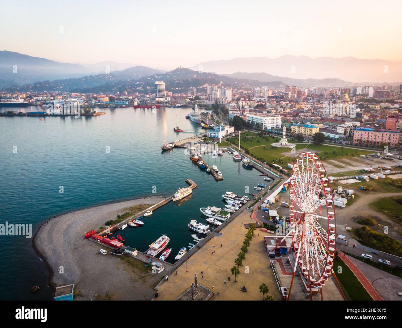 Batumi port with many ships and boats standing and cauacasus mountains ...