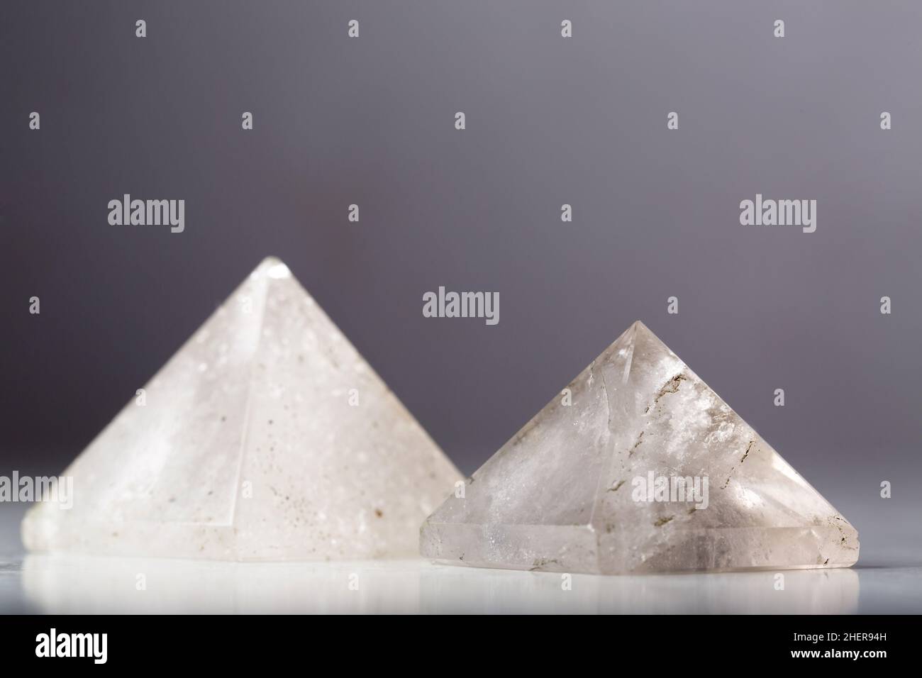 Natural rock crystal pyramid against a dark background, Reiki concept ...