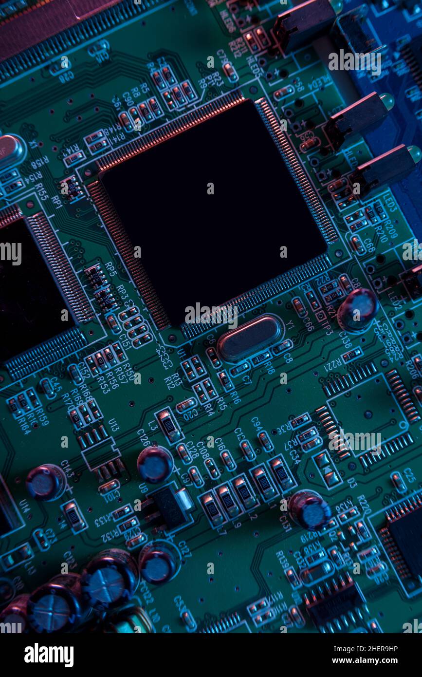 Microcircuit with chip close up with neon lighting. Chip shortage Stock ...