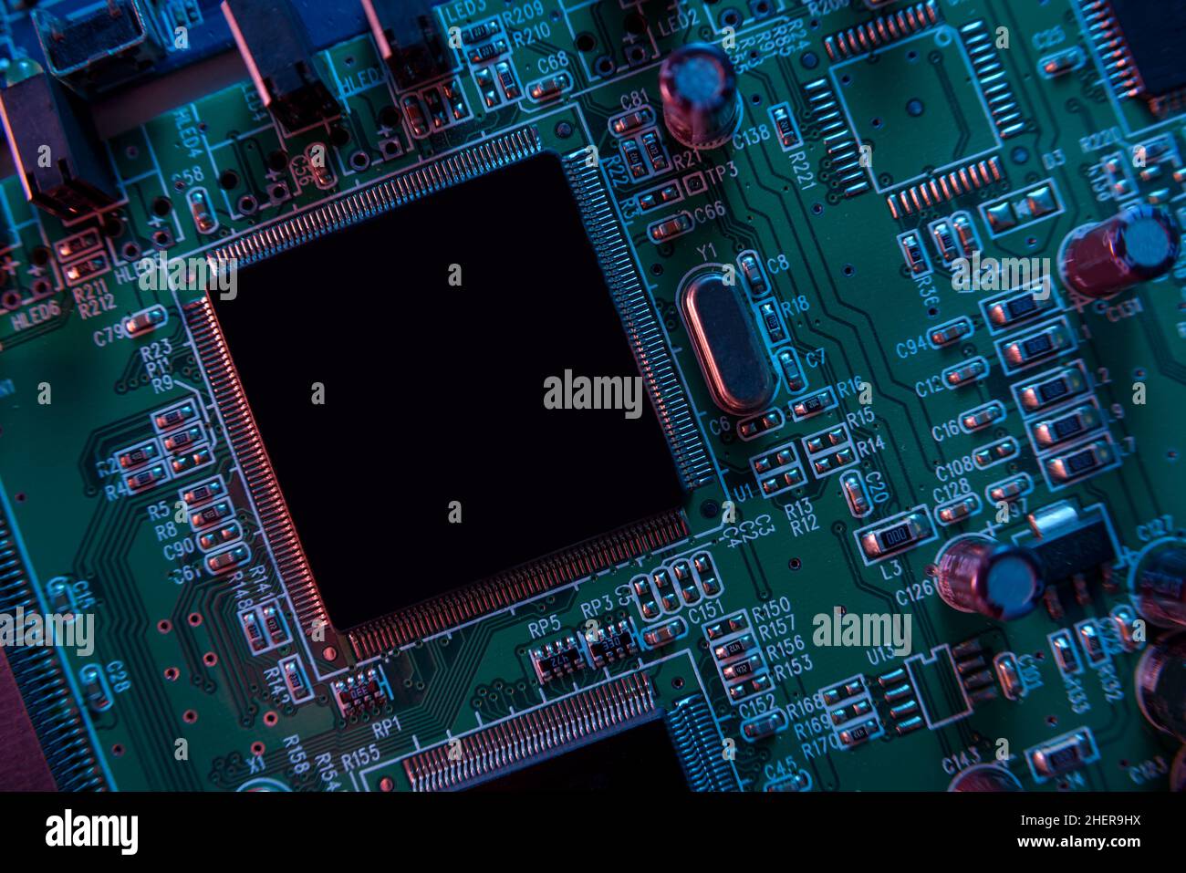 Microcircuit with chip close up with neon lighting. Chip shortage Stock ...