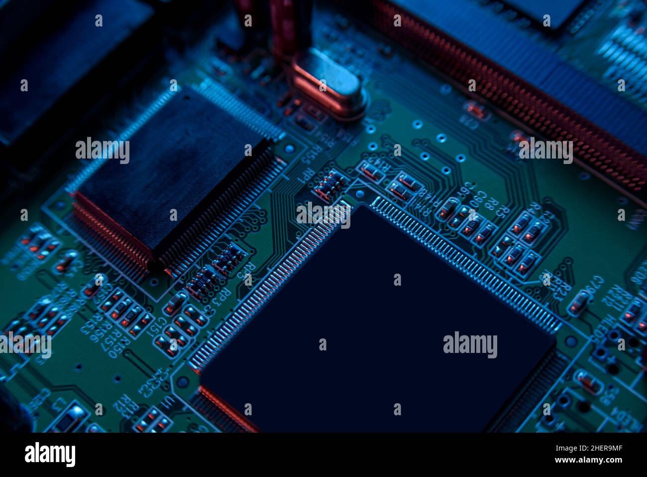 Microcircuit with chip close up with neon lighting. Chip shortage Stock ...