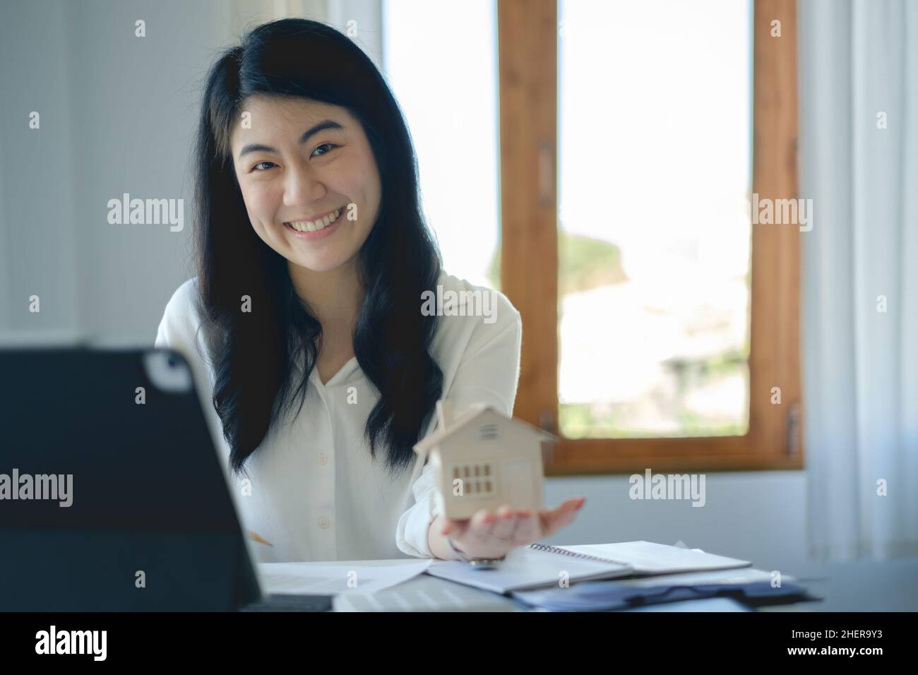 A woman holding and checking house model .Real Estate House Appraisal And Inspection and ...