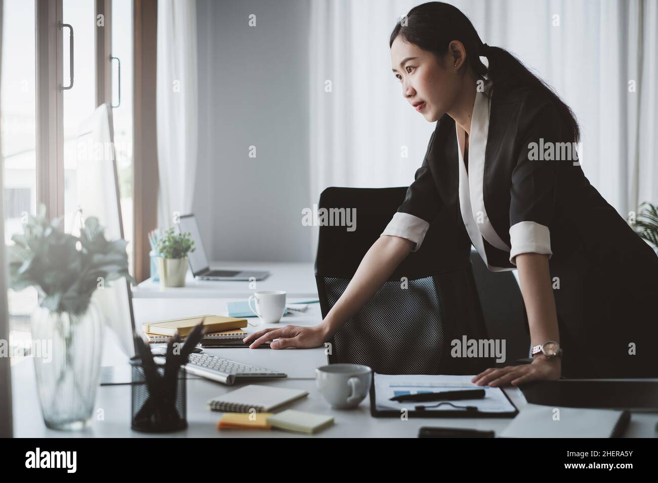 Asian business woman using computer desktop talk to colleagues for ...