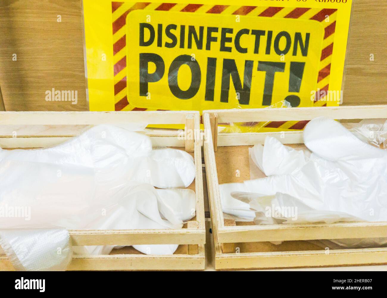 Wooden boxes at the the entrance of the shop with disposable gloves and ...