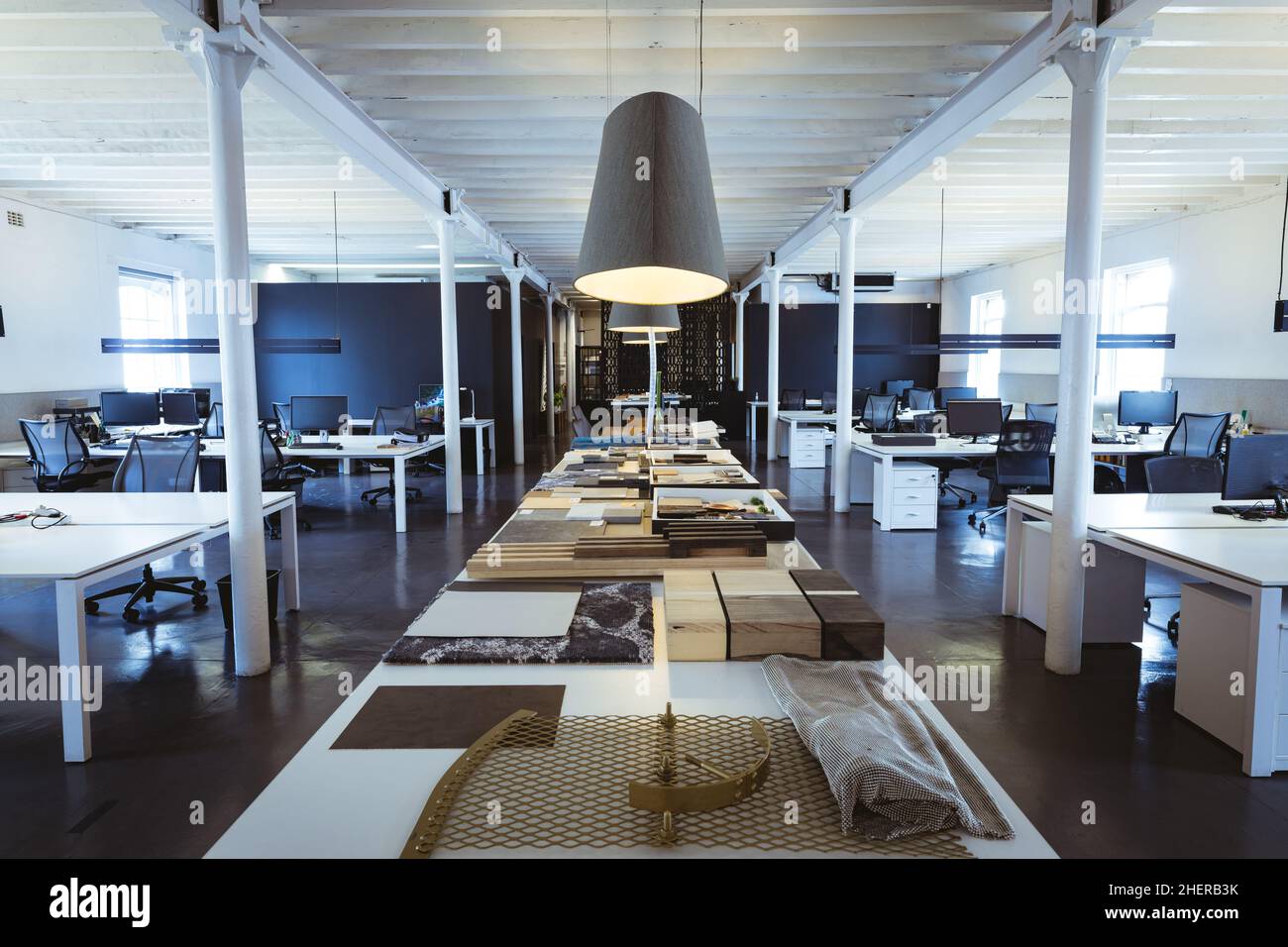 Interior of modern creative office with fabrics and frames on table ...