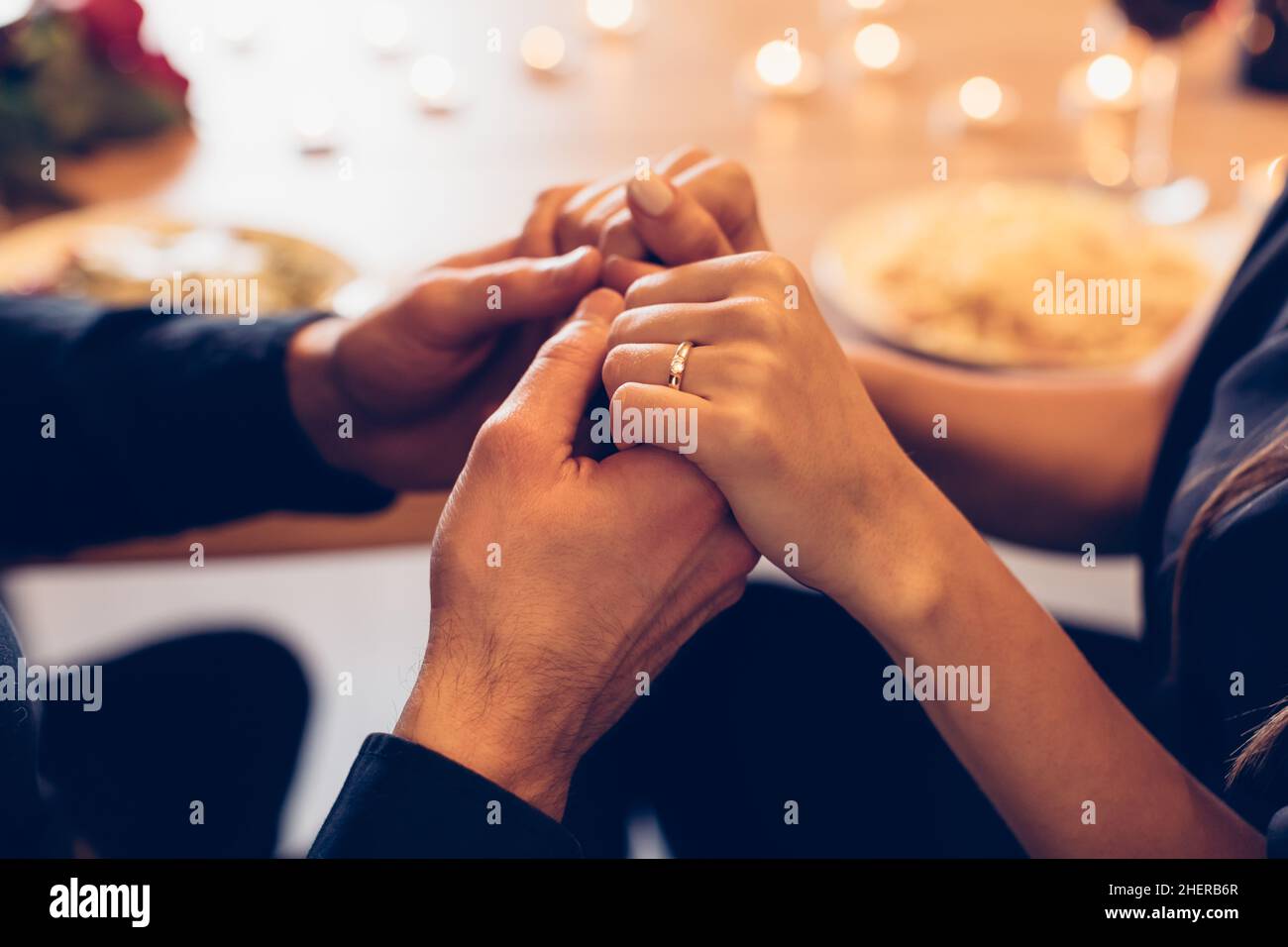 Couple holding hands dinner table hi-res stock photography and images ...