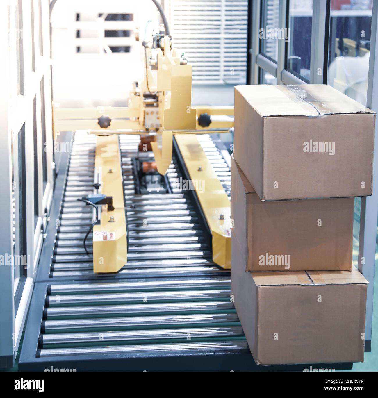 Automated carton, cardboard tape sealing machine. Industrial logistics ...