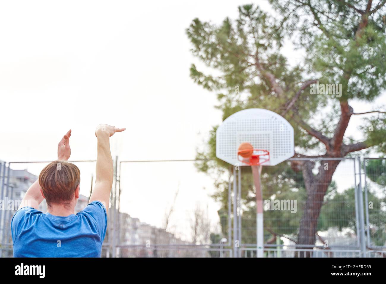 Young player throwing to the basket. Unrecognizable Caucasian man with ...