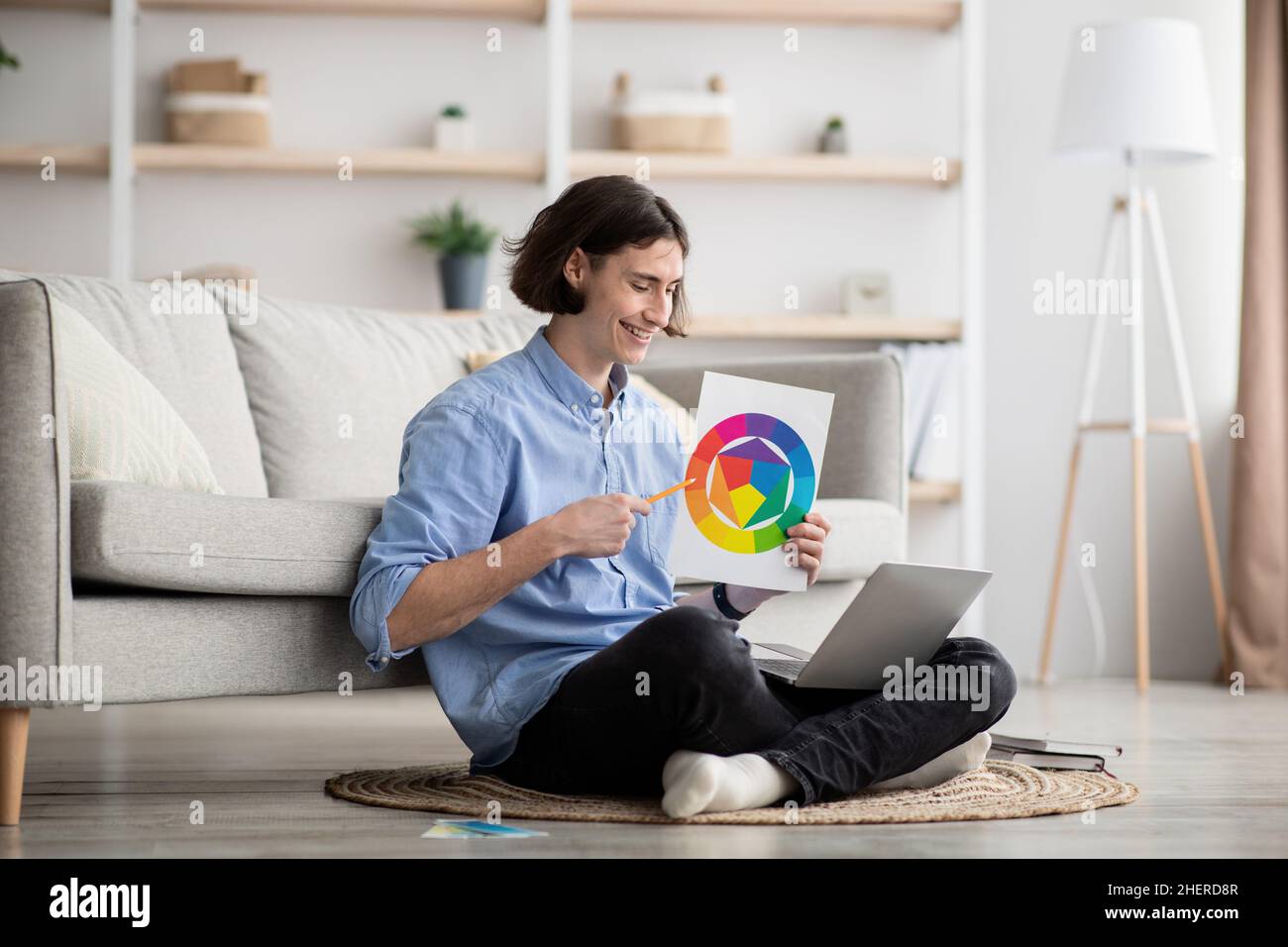 Excited male art-manager having video conference from home, holding ...