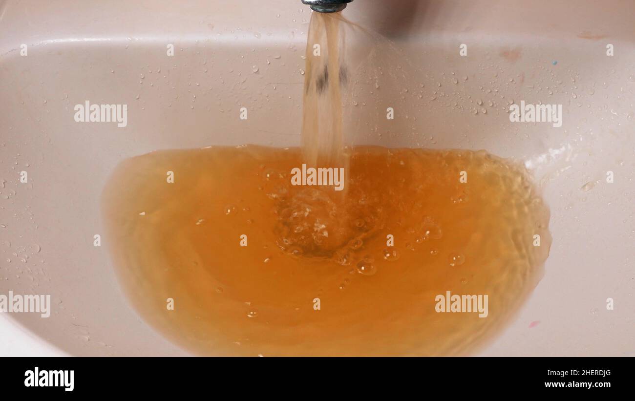 Rusty Water Pours From Tap. Water Pollution. Global Environment Stock ...