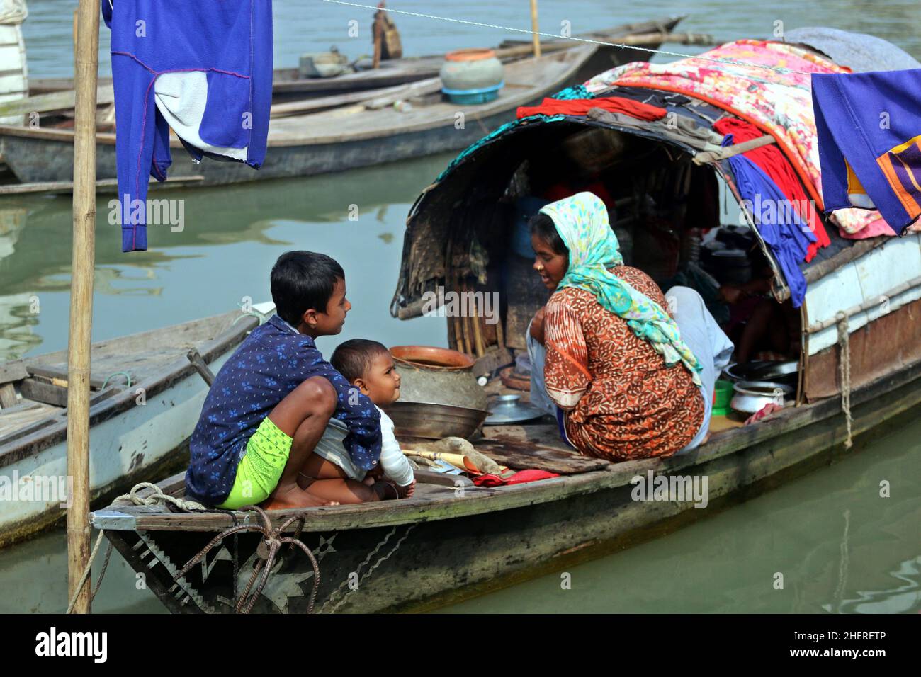 JANUARY 01,2022,DHAKA,BANGLADESH- A Gypsy family sitting in their boat ...