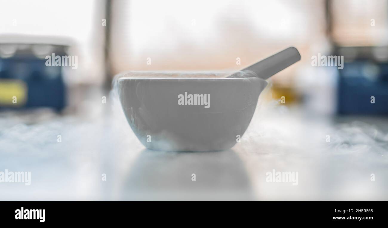 Laboratory experiment with liquid nitrogen in laboratory mortar with ...