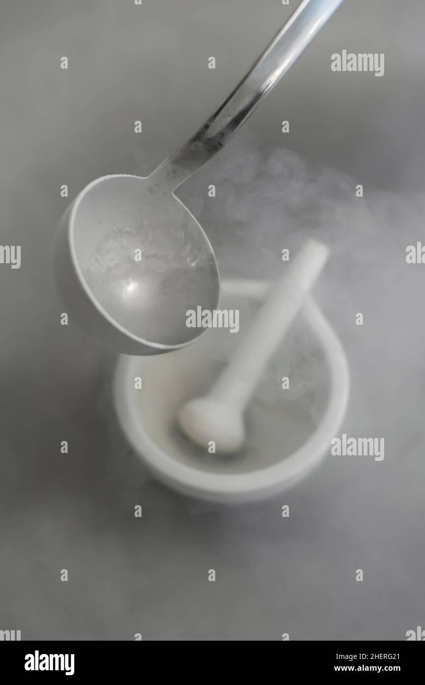 Laboratory experiment with liquid nitrogen in laboratory mortar with ...