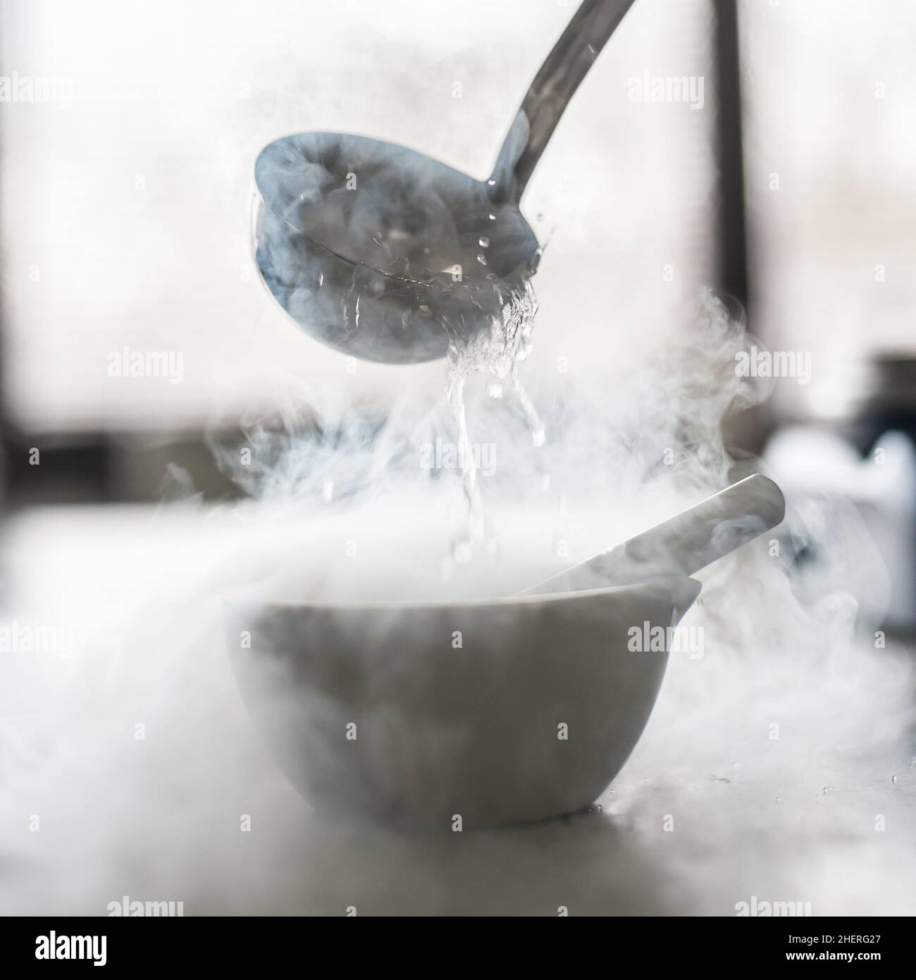 Laboratory experiment with liquid nitrogen in laboratory mortar with ...