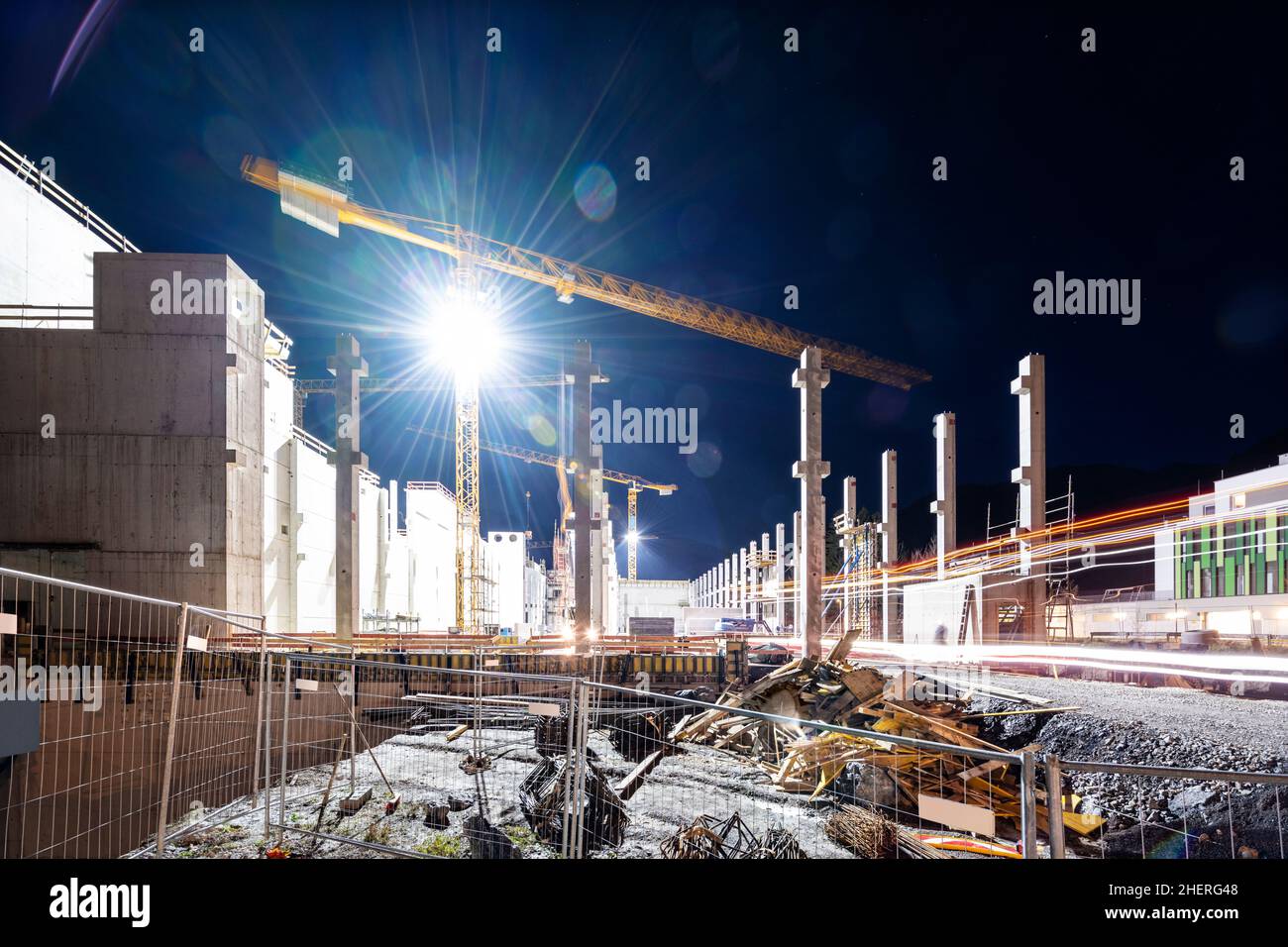 Floodlit tower crane on building construction site at night Stock Photo ...