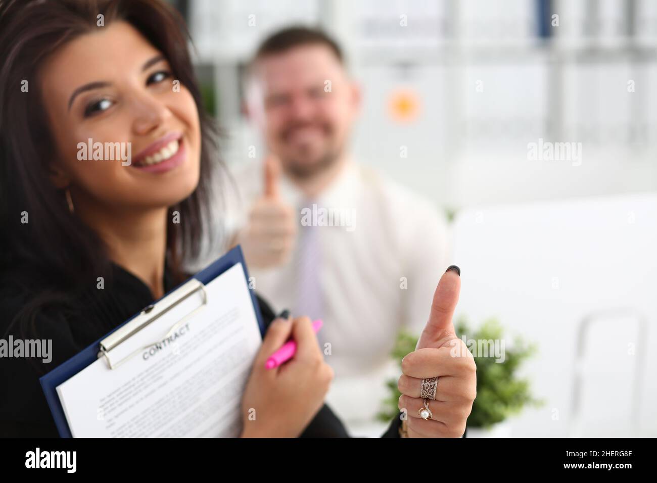 Female hand showing thumbs up OK gesture at meeting Stock Photo - Alamy