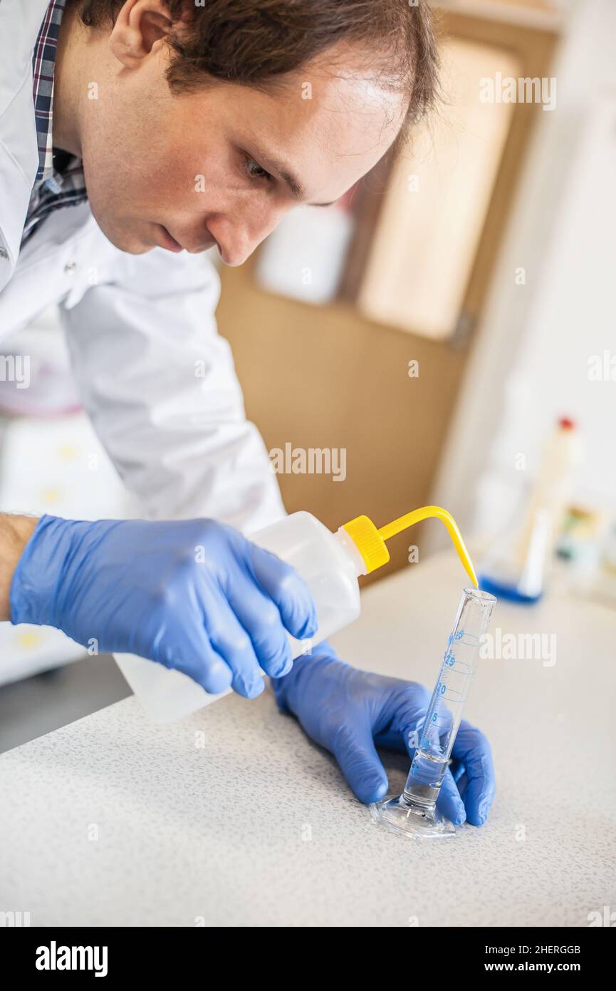 Male laboratory researcher performs tests in the medical or scientific ...