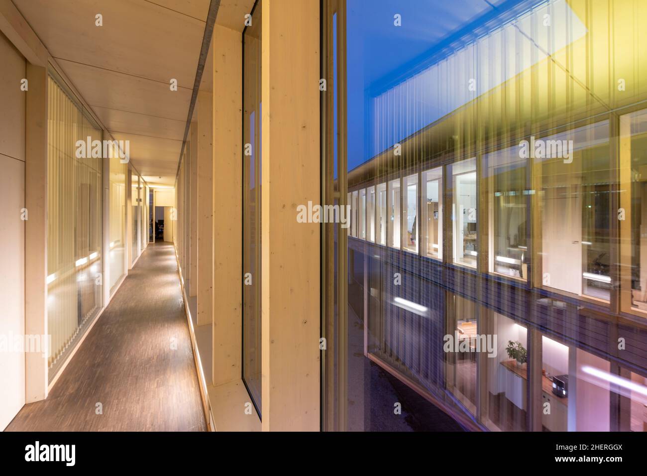 View from aisle of a wood construction office building through window ...