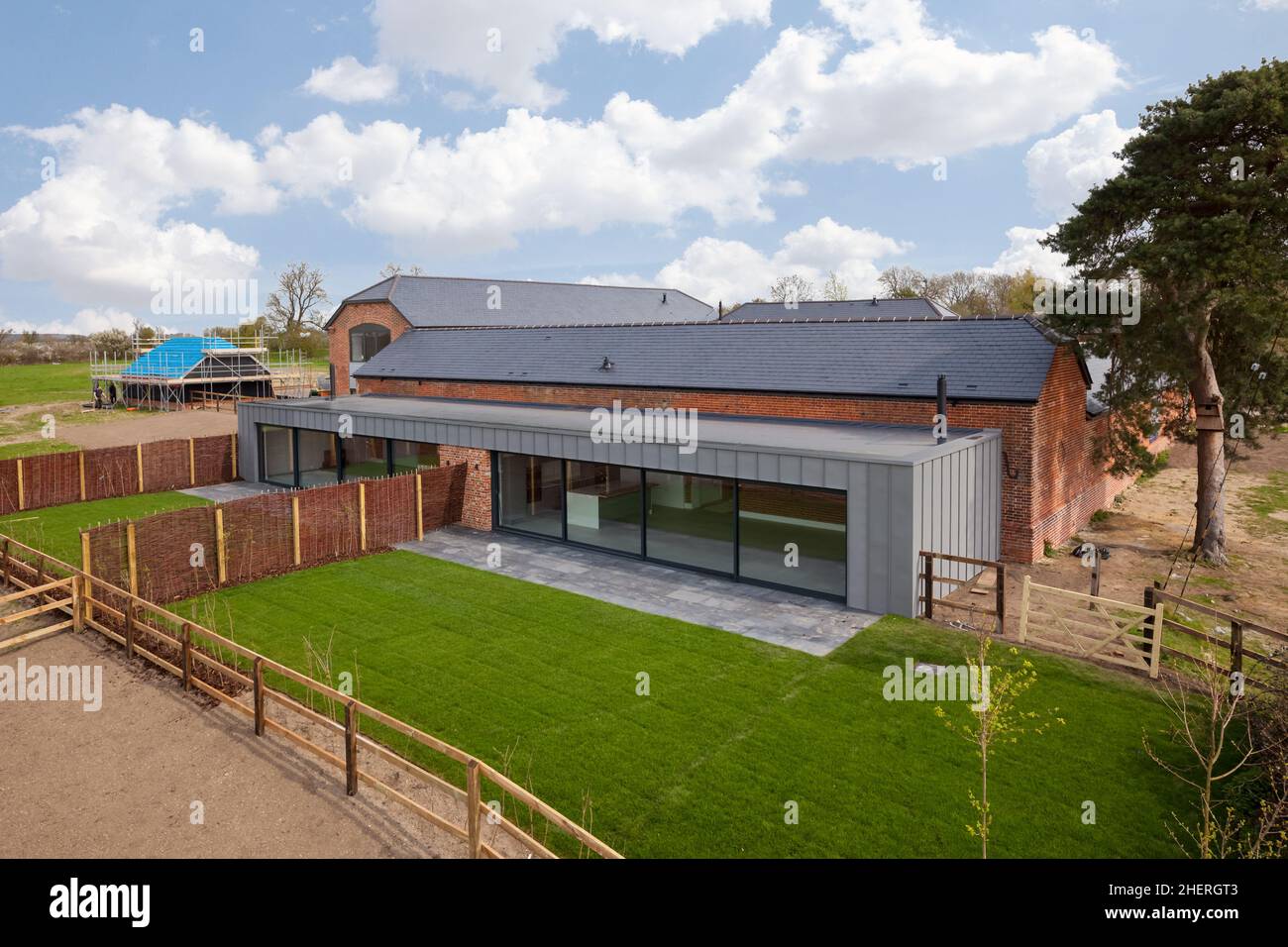 Cowlinge, Suffolk, England - 9 April 2019: Aerial view of stylish brick ...