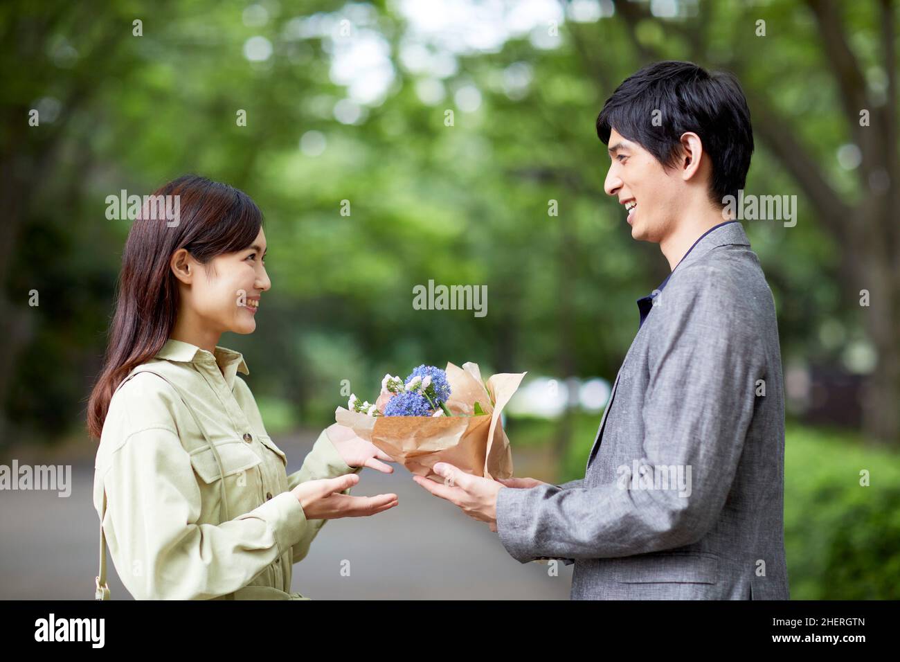 Woman passing flowers hi-res stock photography and images - Alamy