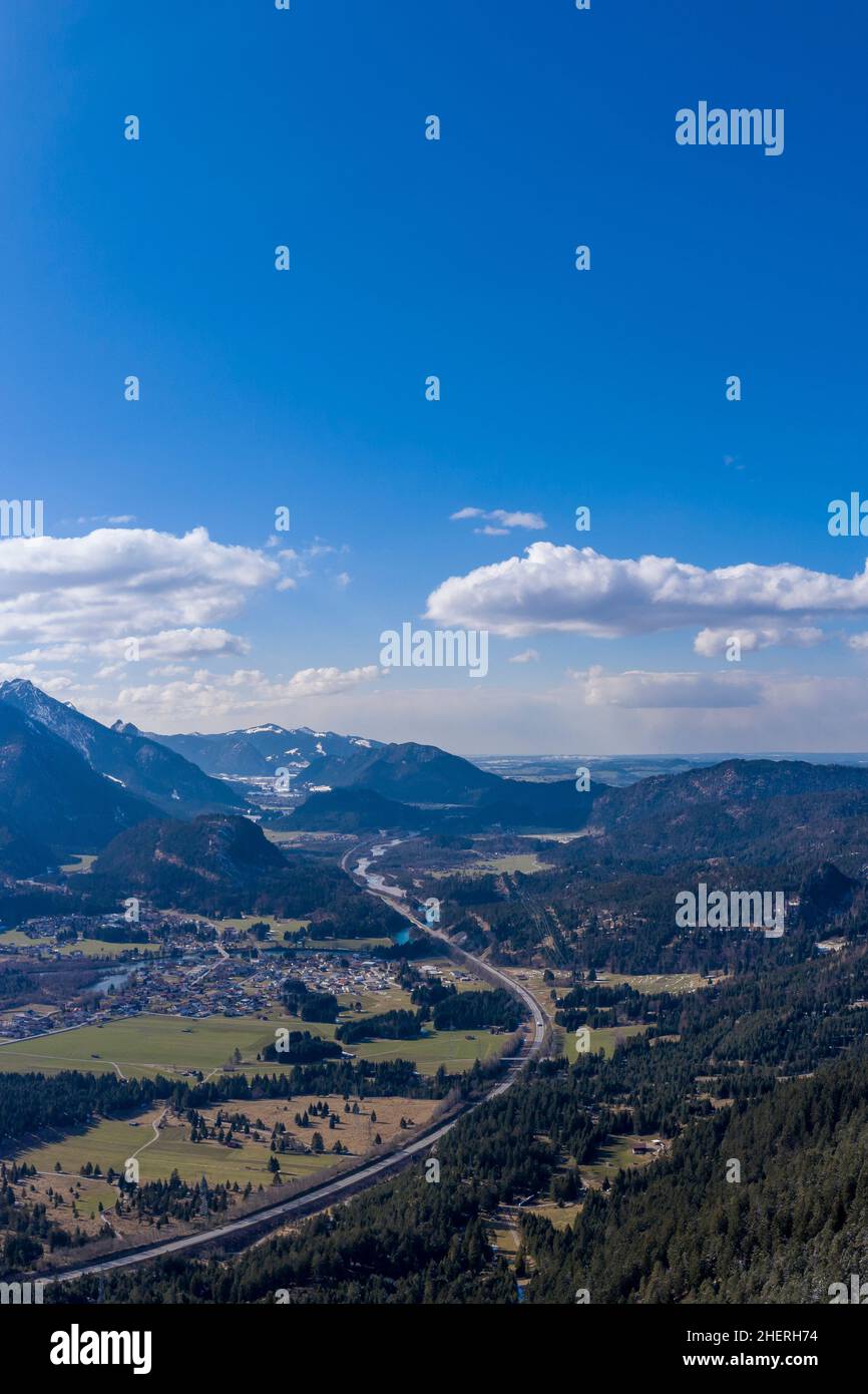Vertical view to highway through rural village Pflach in Tirol to ...