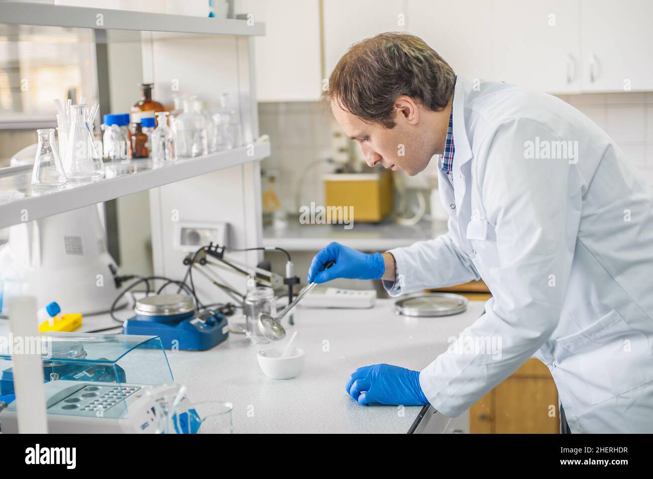 Male laboratory researcher performs tests in the medical or scientific ...