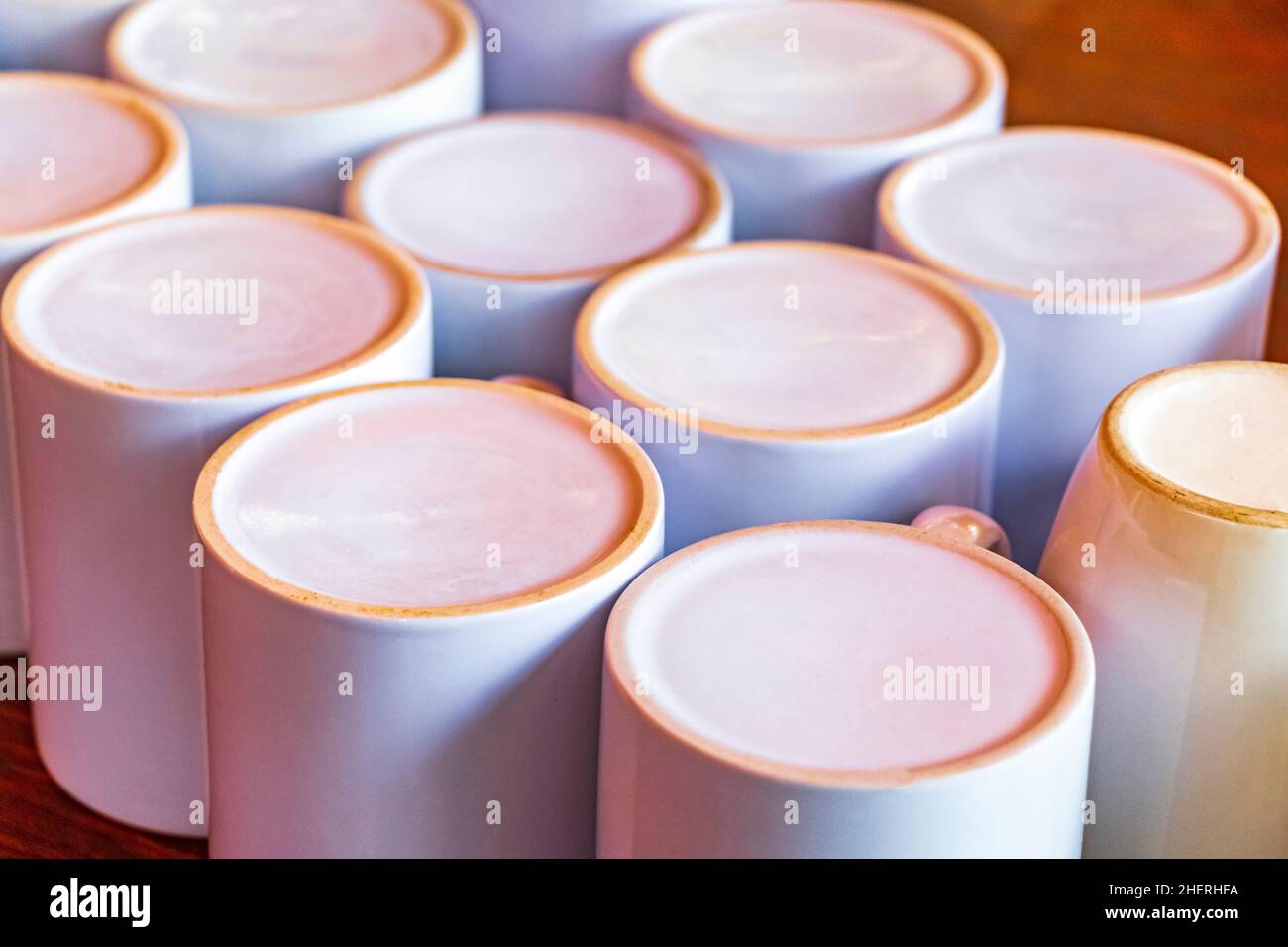 White coffee and tea cups on a brown wooden table in tropical nature ...