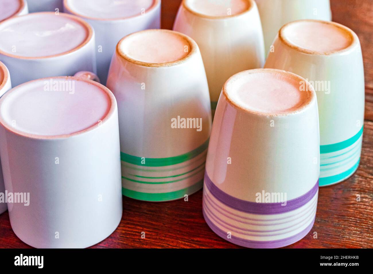 White coffee and tea cups on a brown wooden table in tropical nature ...