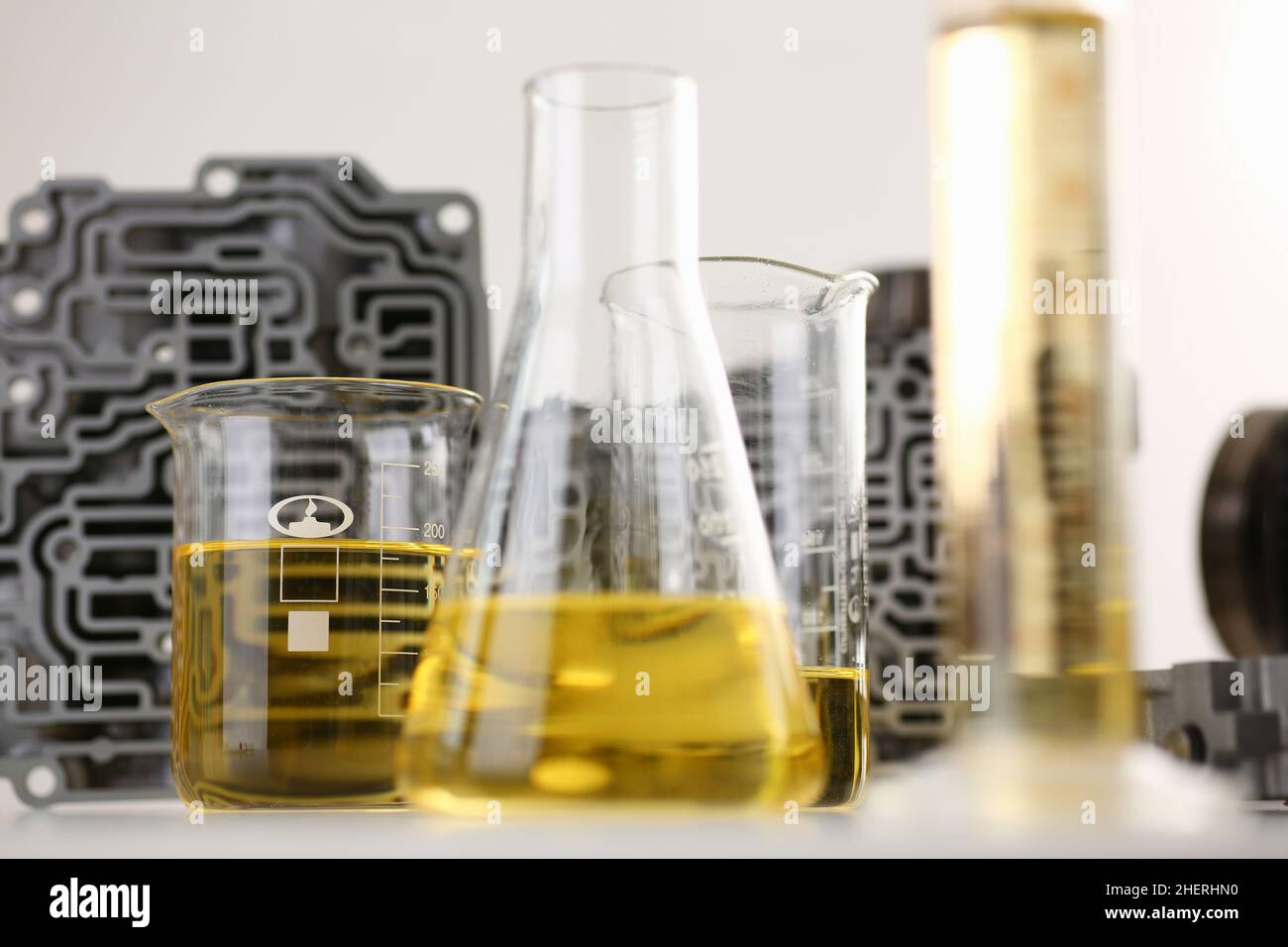 Test tube chemistry flask against of hydroblock acp with yellow liquid ...