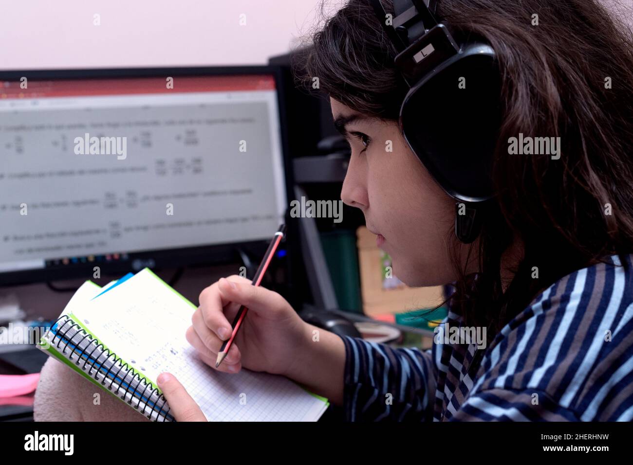 Transgender teenager studying in front of the computer out of focus ...