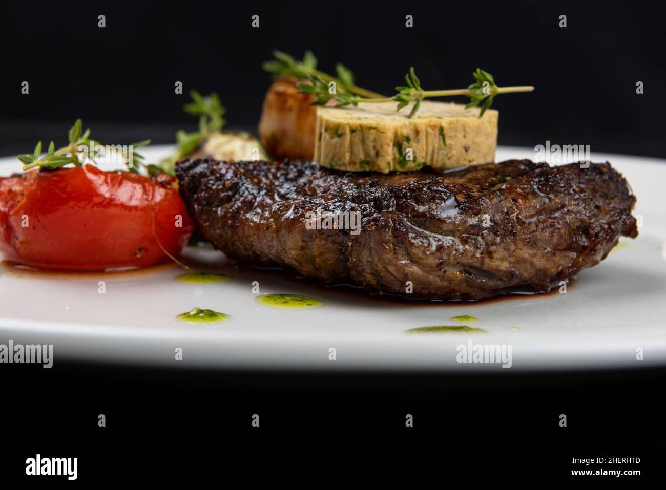 Grilled black angus strip loin steak with vegetables Stock Photo - Alamy