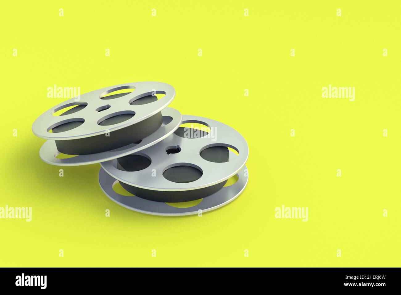 Film reel in metal frame on yellow background. Cinematography tape ...