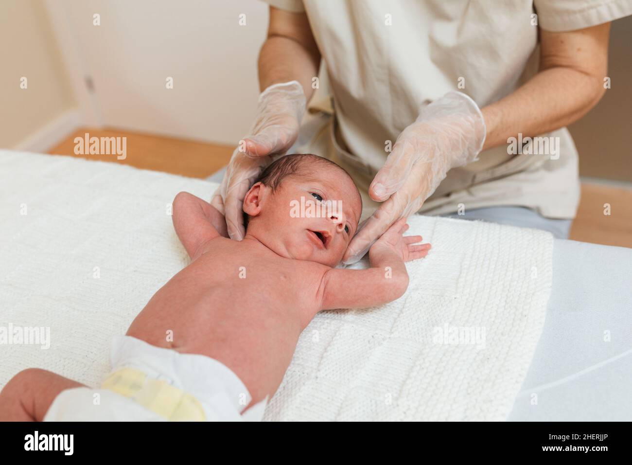 Little baby receiving a physiotherapy treatment in a therapy center ...
