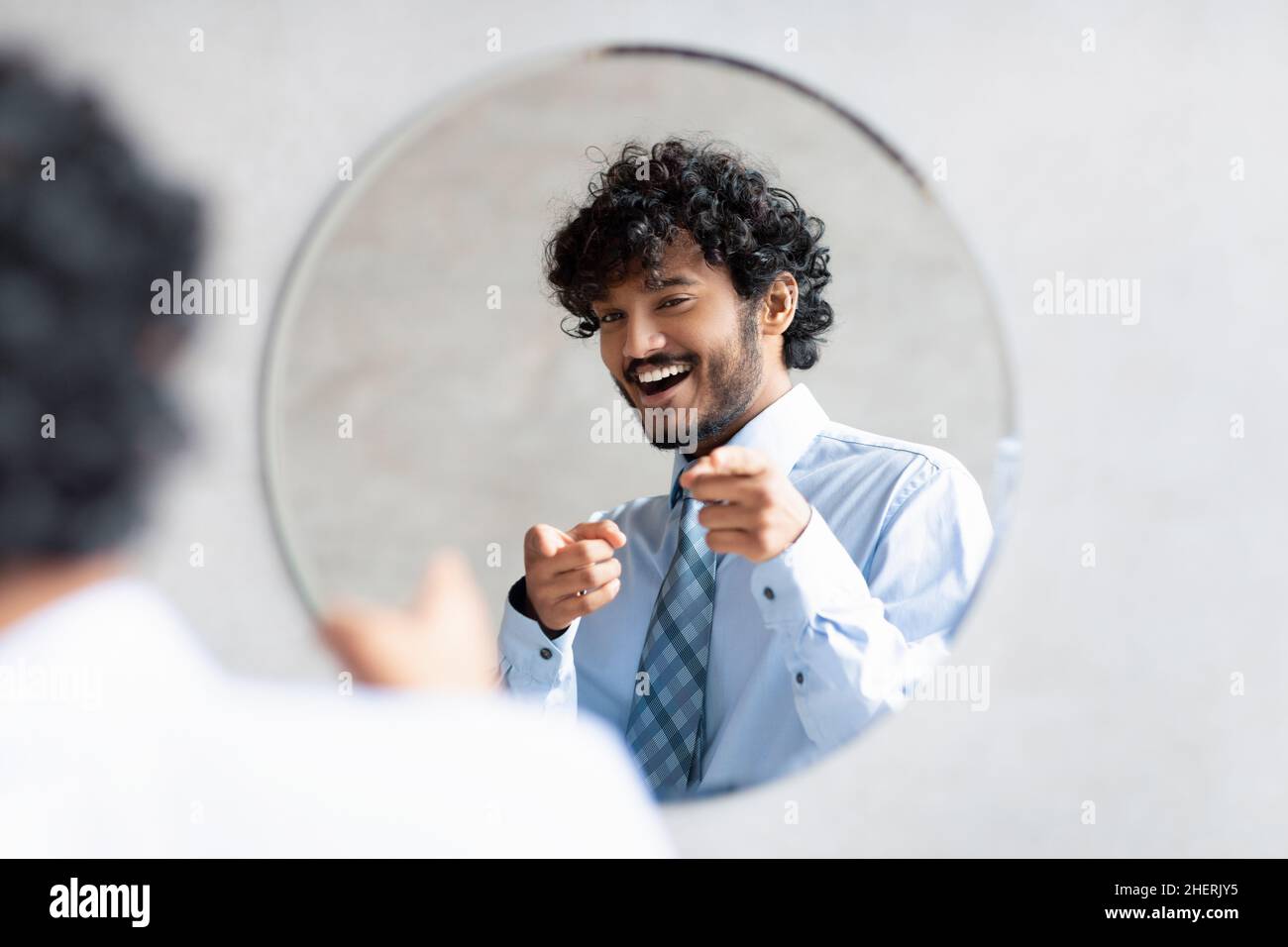 You're handsome. Confident indian businessman pointing at mirror in ...