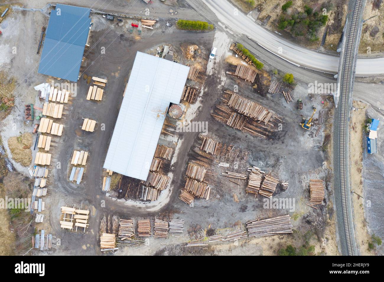aerial drone view from top to sawmill with tree wood trunk staples ...