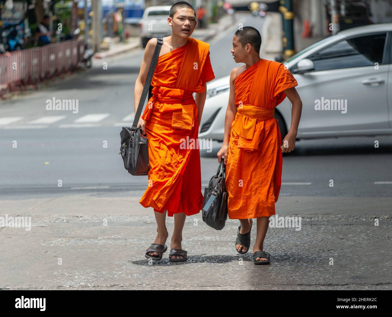 Two young monks walking down a street in Bangkok. Front view Stock ...